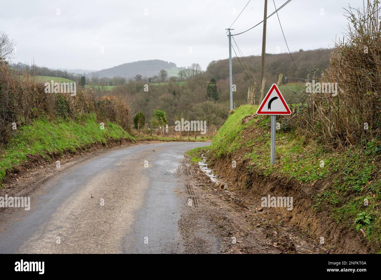 Road and road sign warning about a turn in the road. Road safety ...