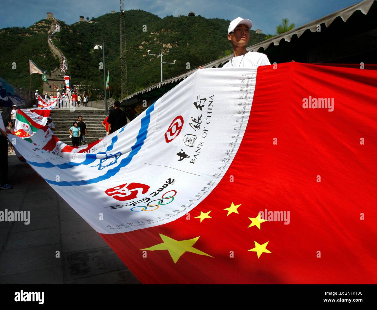 Volunteers unfurl a 13,112-meter-long "Olympic Dragon" scroll at the ...