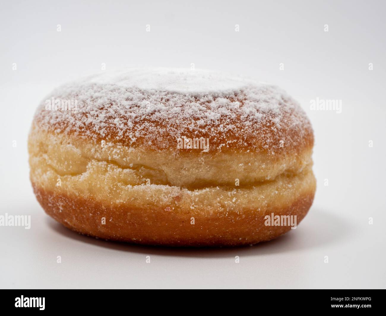 Freshly baked and dusted with powdered sugar German donuts. Donut ...