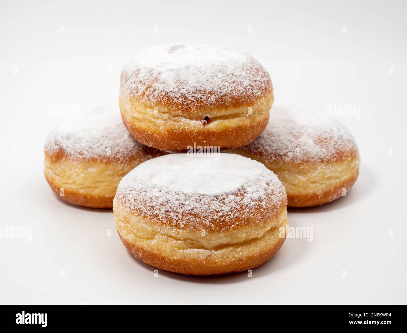 Freshly baked and dusted with powdered sugar German donuts. Donut ...