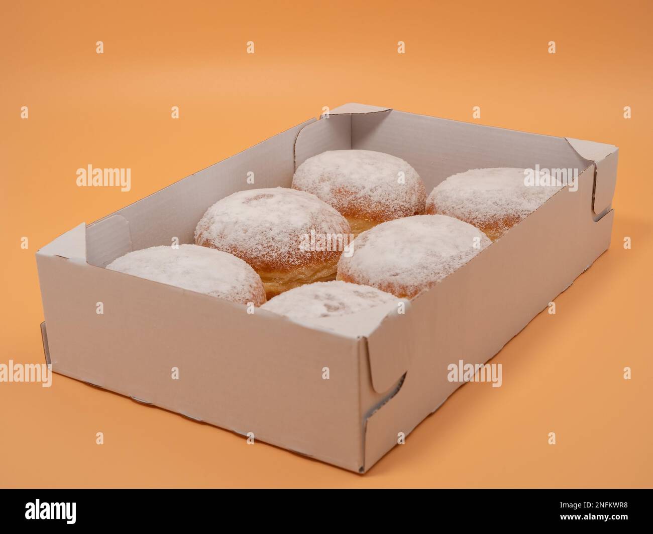 Freshly baked and dusted with powdered sugar German donuts. Donut ...