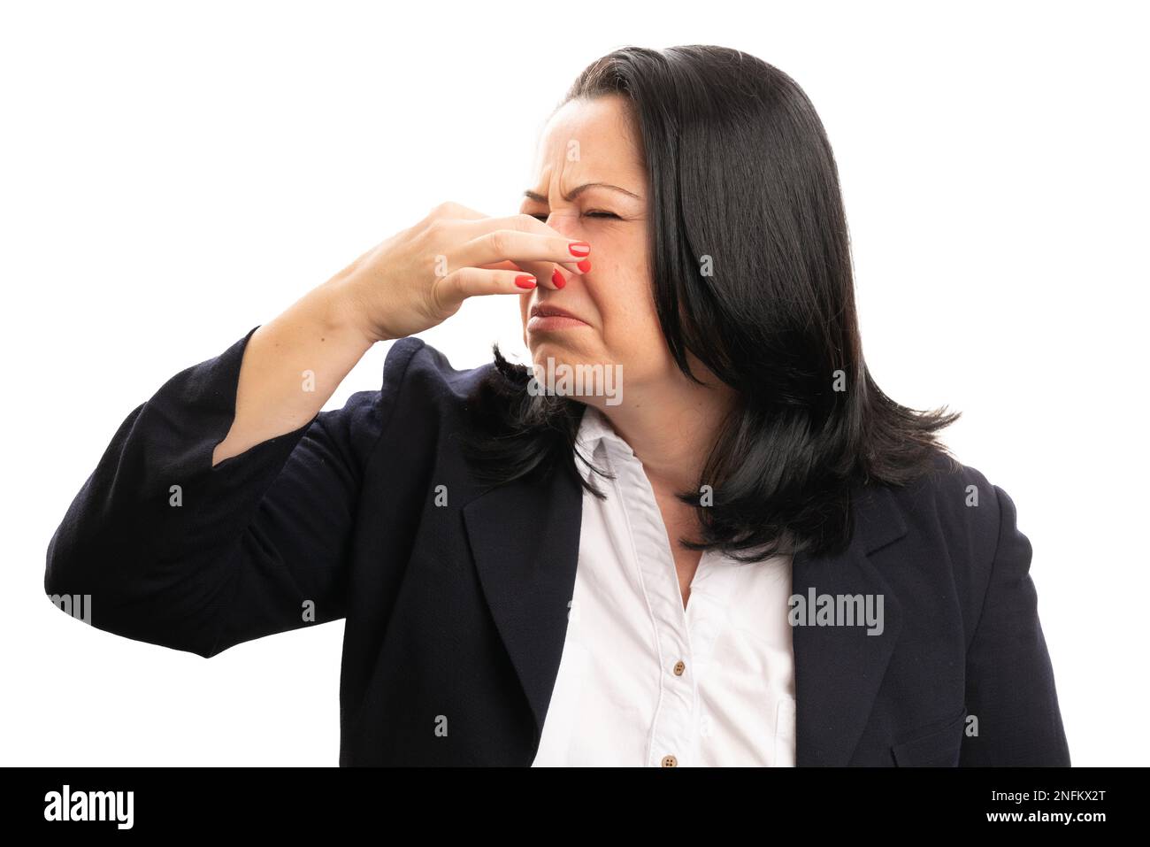 Close-up of adult businesswoman in formalwear holding nose as bad smell ...