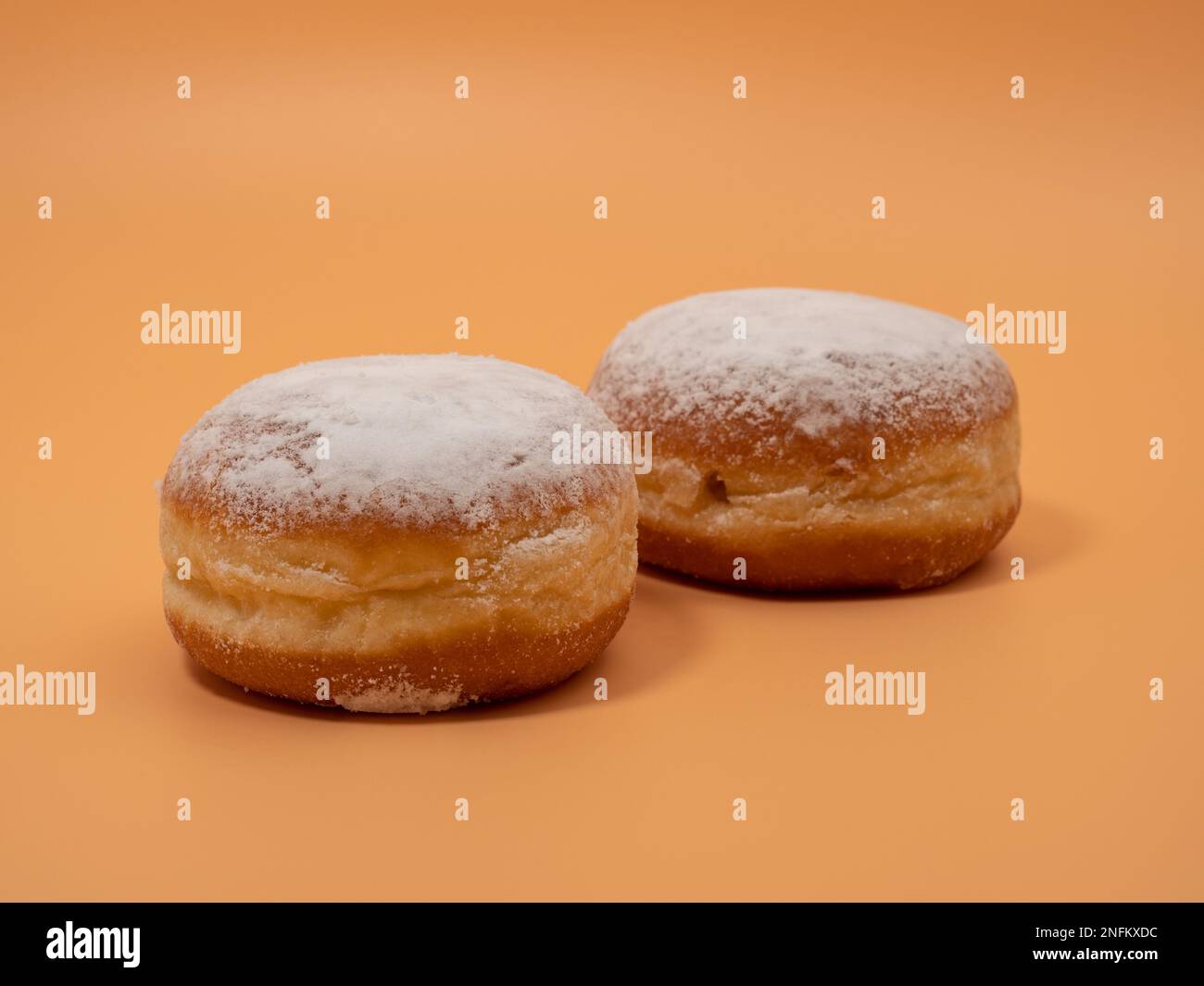 Freshly baked and dusted with powdered sugar German donuts. Donut ...