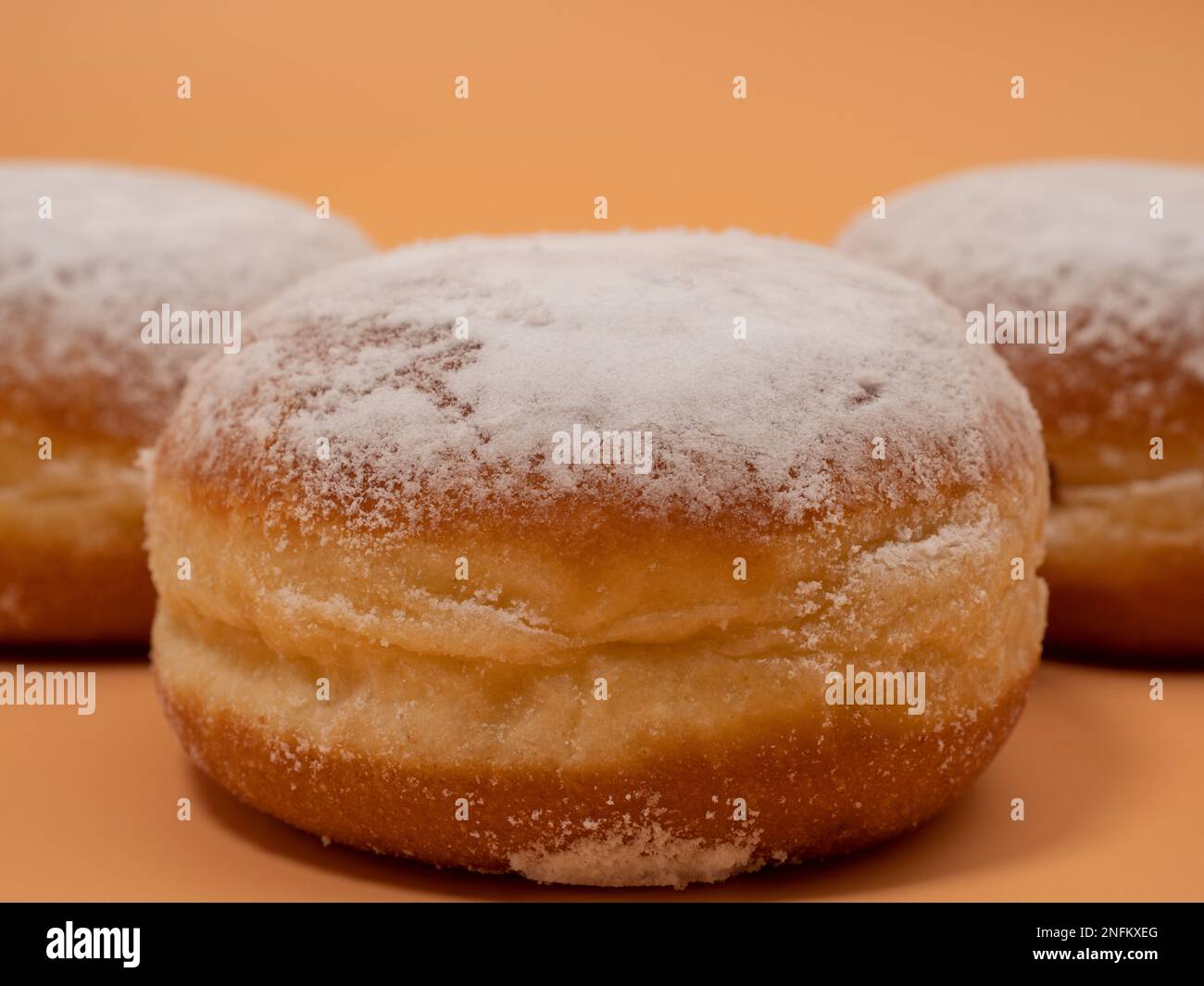 Freshly baked and dusted with powdered sugar German donuts. Donut ...