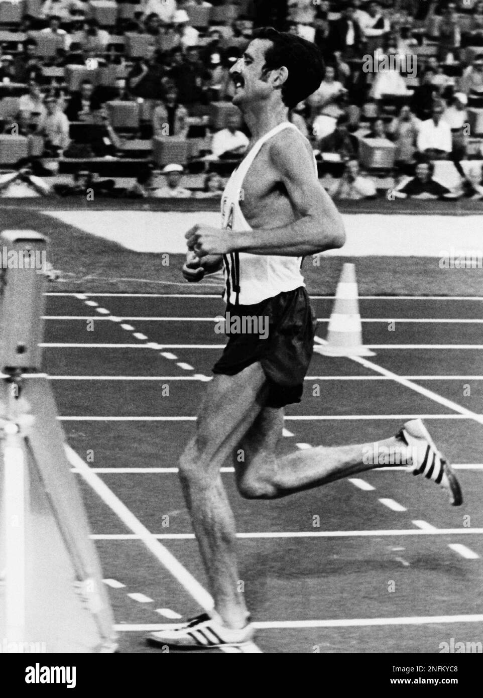 Marathon runner Frank Shorter of the U.S. smiles in victory as he ...