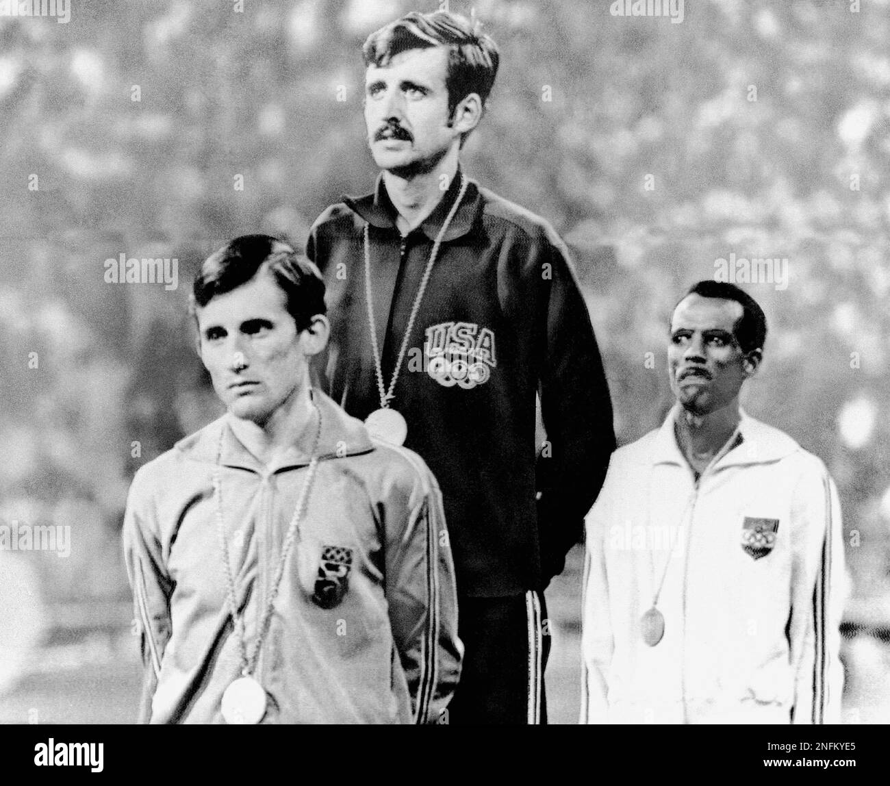 Marathon runner Frank Shorter, center, stands above his competitors ...