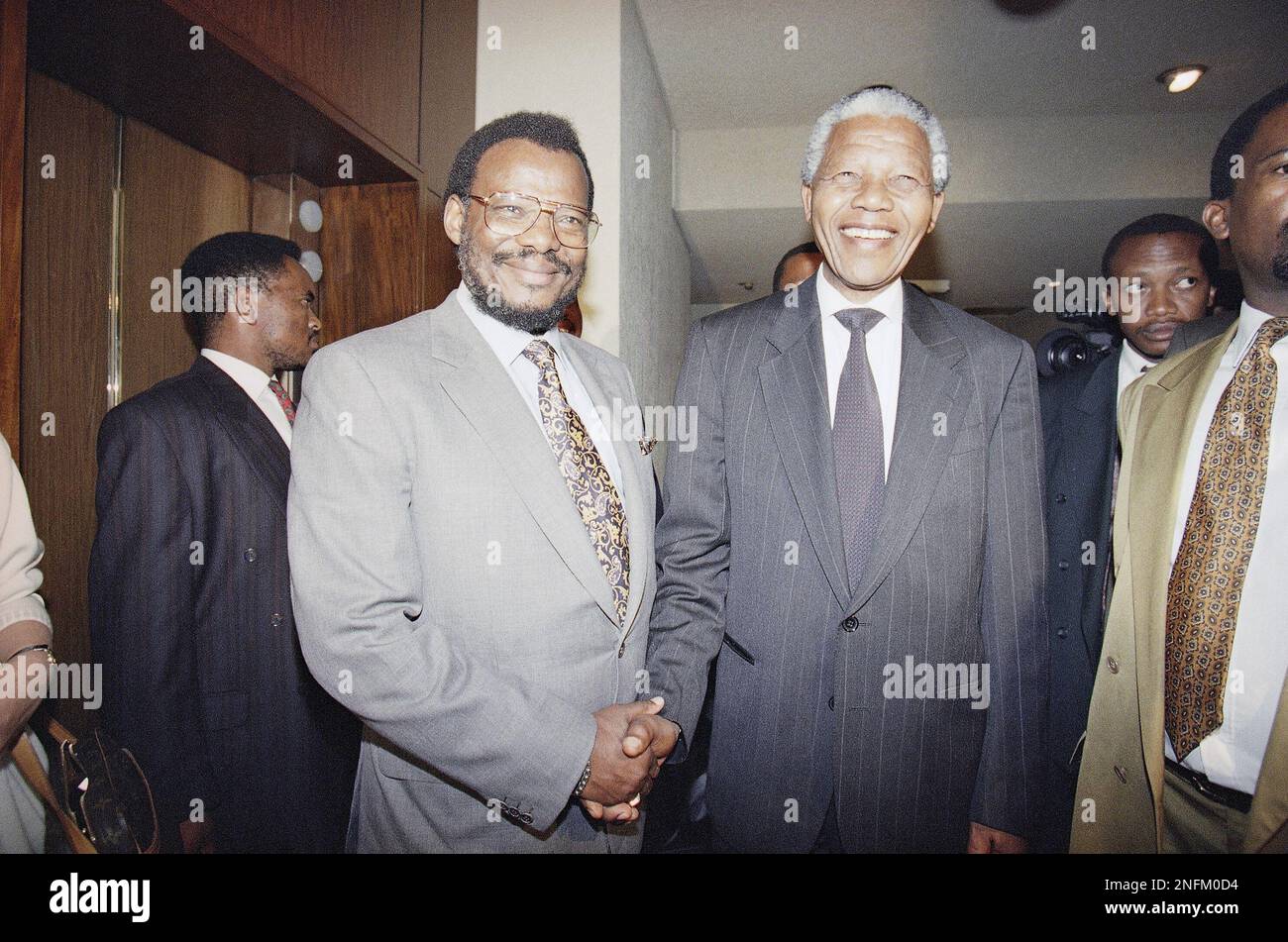 Zulu Inkatha Freedom Party leader Mangosuthu Buthelezi, left, shakes hands with African National ...