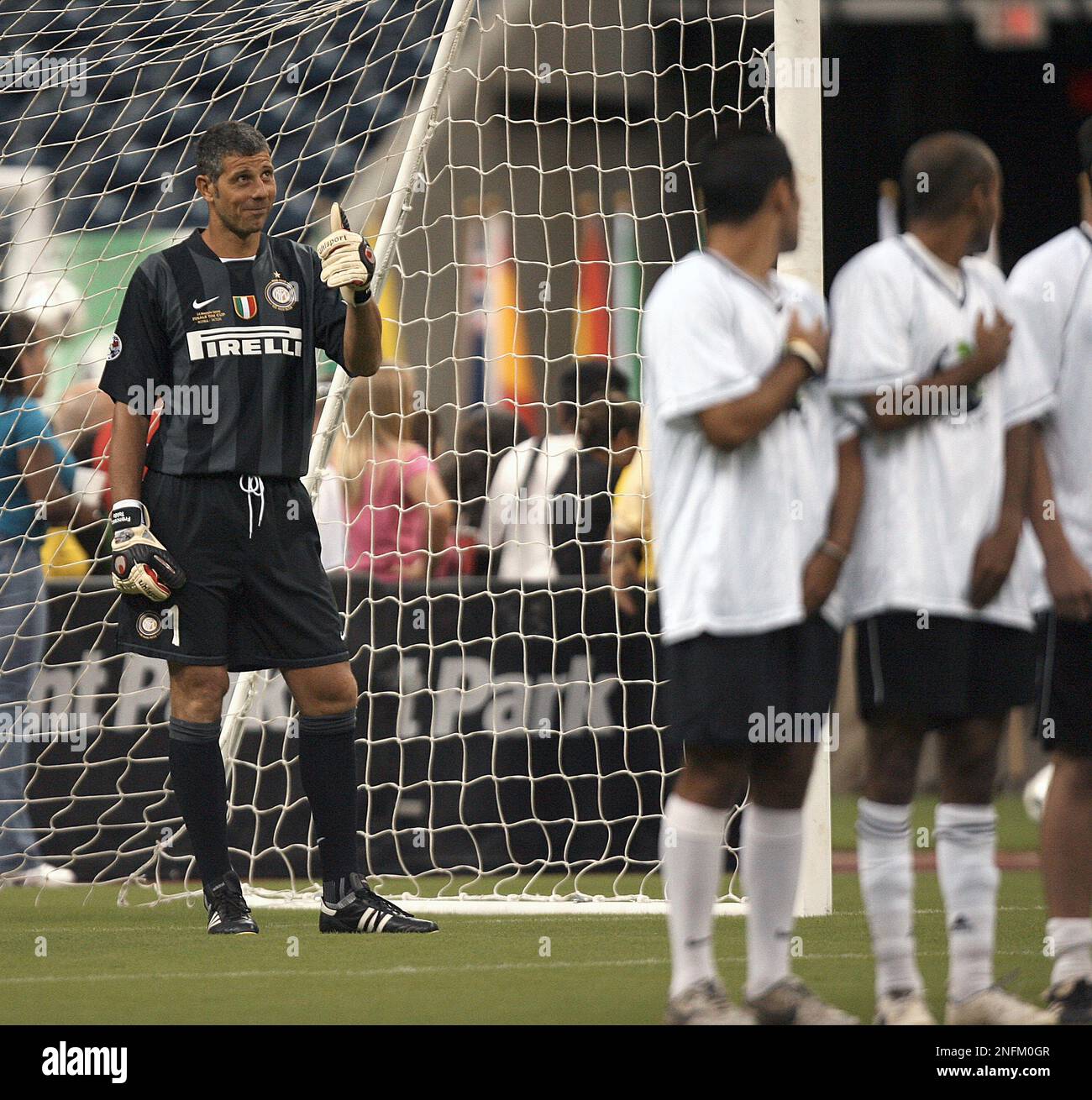 Goalkeeper Francesco Toldo, of Italy, positions the wall of players ...