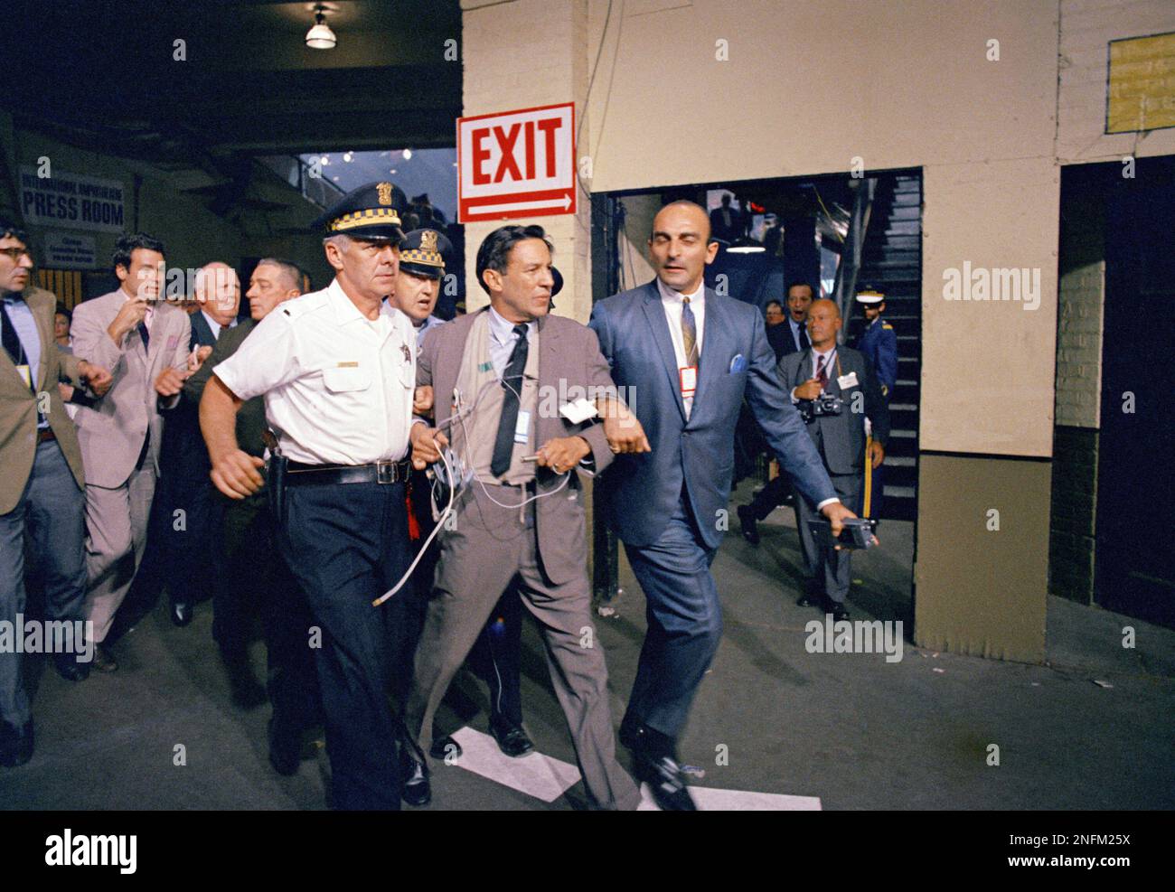 Mike Wallace, CBS-TV newsman, is hustled off the Democratic National ...