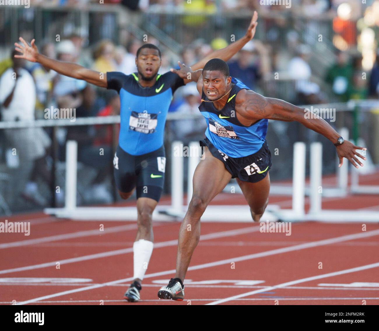 David Oliver, right, crosses the finish line ahead of David Payne in ...