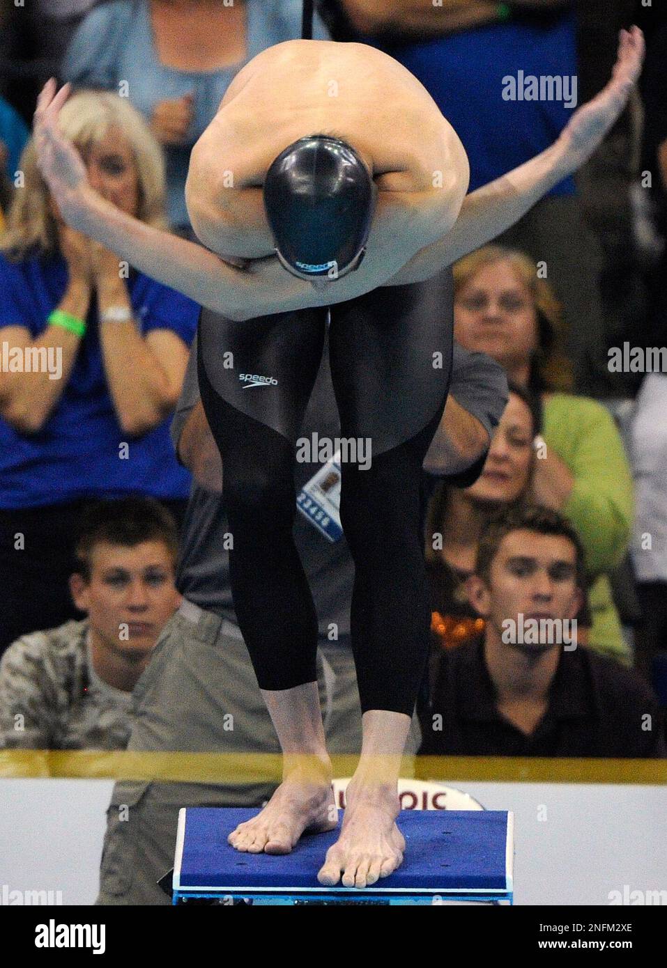 Michael Phelps stretches before swimming in the men's 100-meter ...
