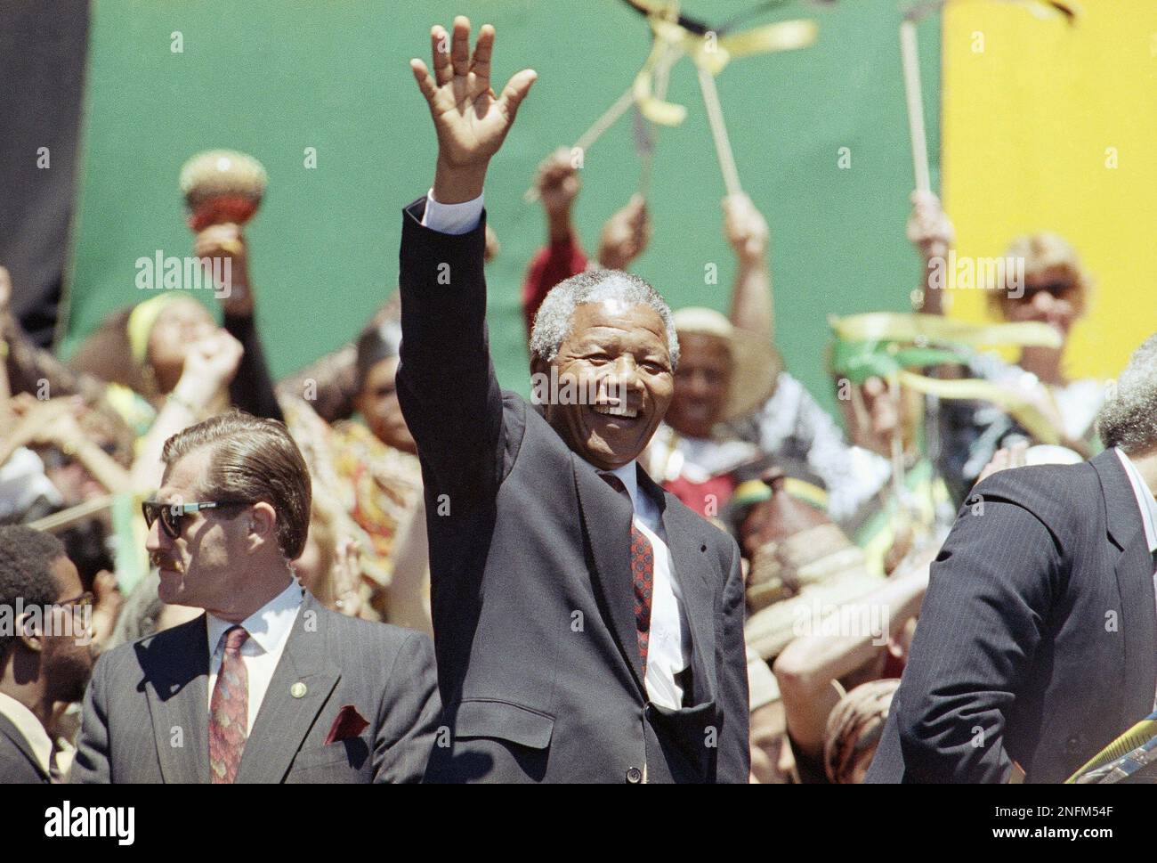 Nelson Mandela waves to a capacity crowd at the Oakland Coliseum ...