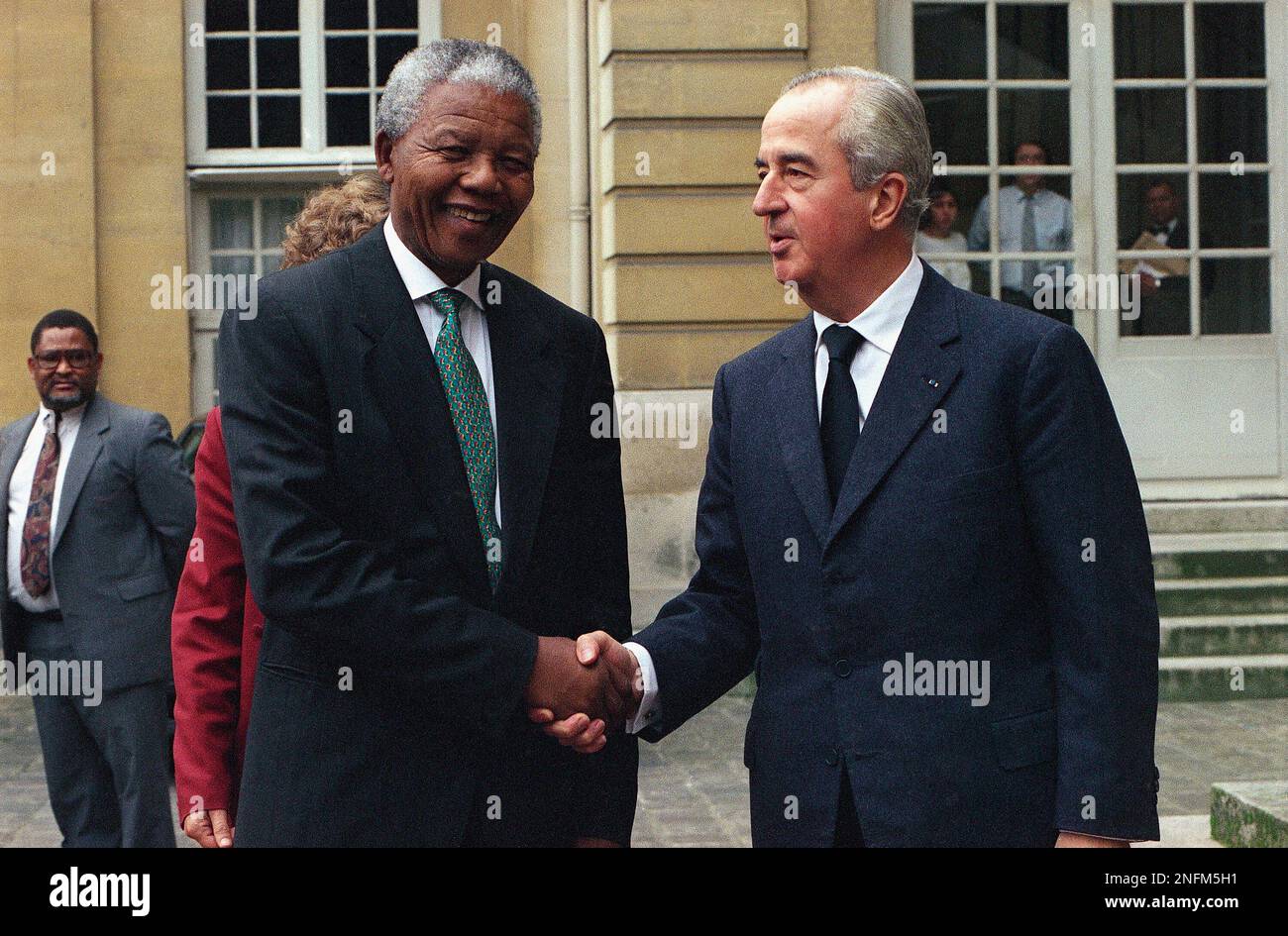African National Congress President Nelson Mandela, left, shakes hands with French Prime ...