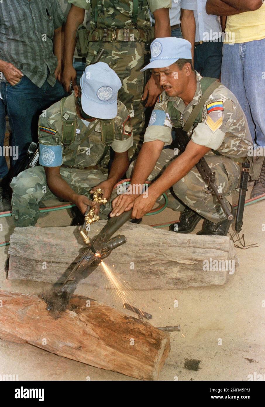 Venezuelan soldiers representing the U.N. Demobilization troops, cut a ...