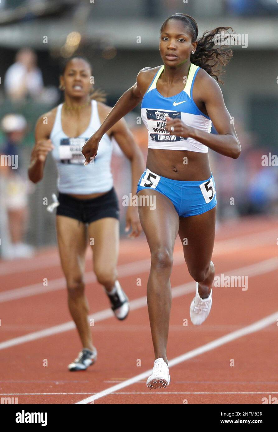 Mary Wineberg, right, crosses the finish line ahead of Debbie Dunn in ...