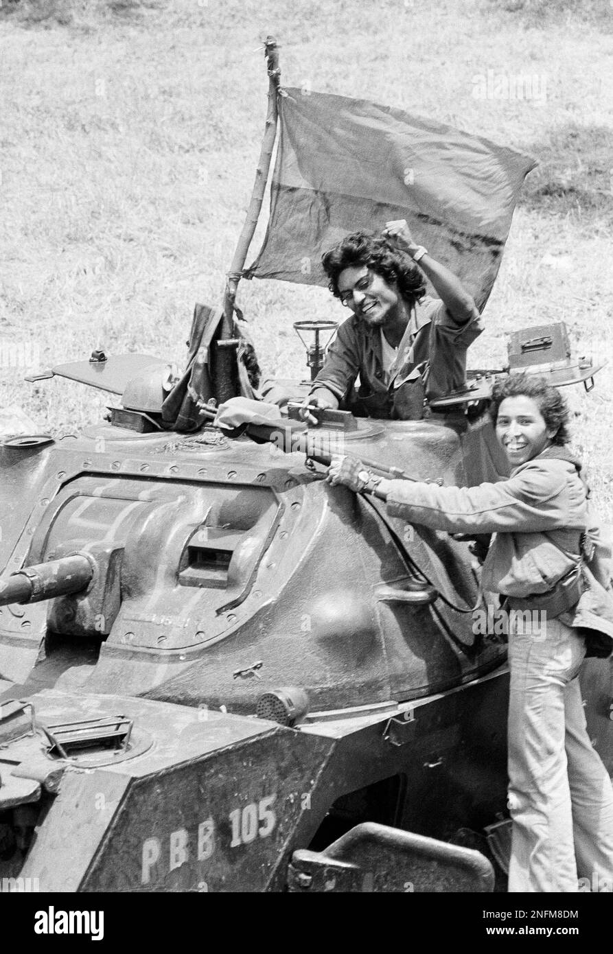A pair of jubilant Sandinista Guerrillas ride into Managua on a tank ...