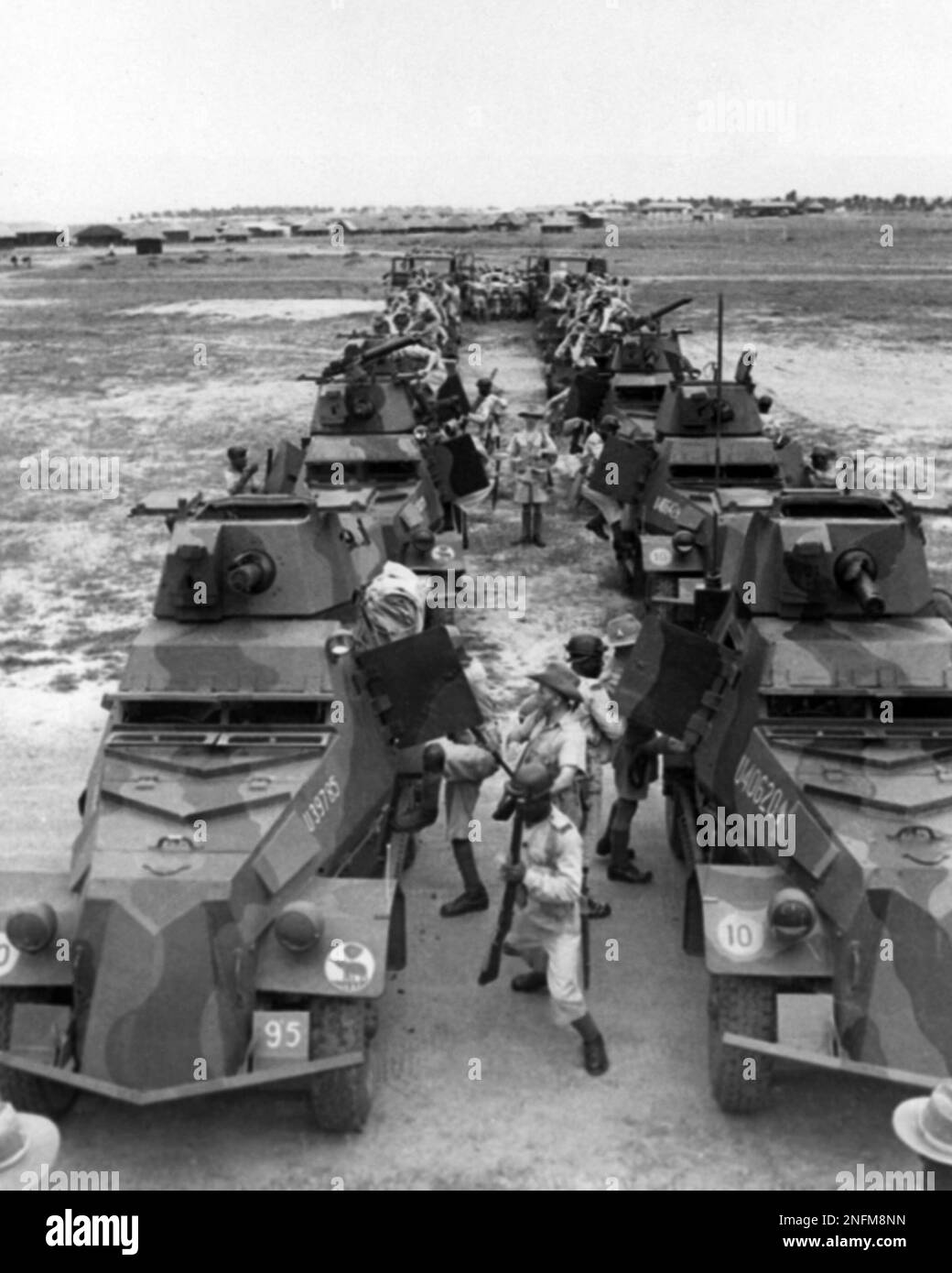 African armored car drivers mount their vehicles from a West African ...