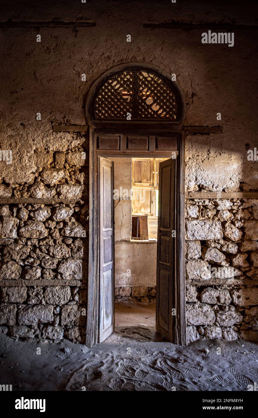 A Vertical shot of the open door of the old and demolished building ...