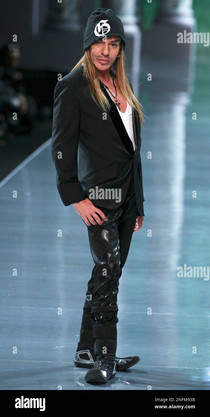British fashion designer John Galliano strikes a pose after the ...