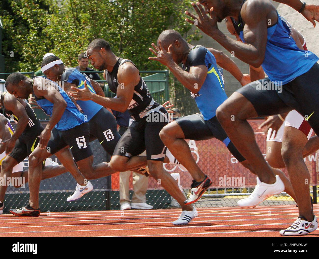 Tyson Gay, center, competes in the first heat of the men's 100 meter ...