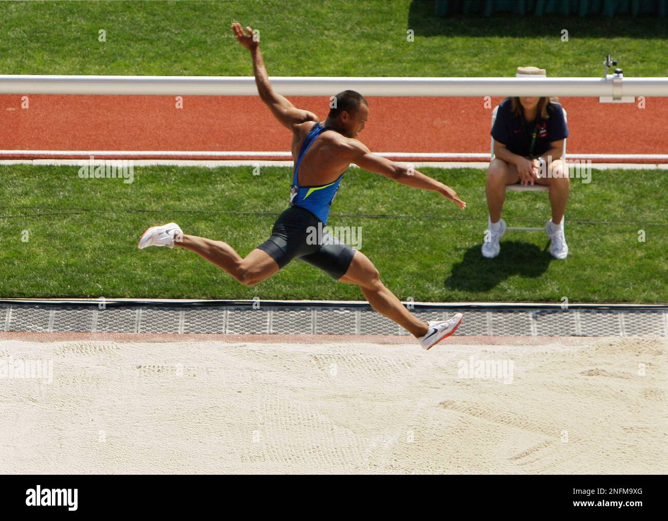 Bryan Clay leaps into the pit during the decathlon long jump event at ...