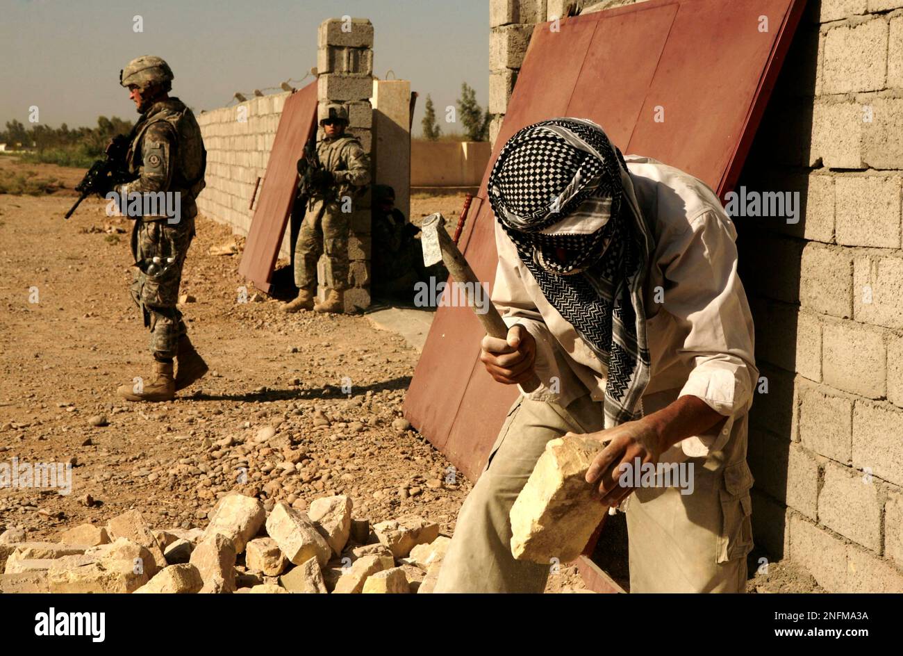 A bricklayer works at the site of a planned fuel station, as U.S. Army ...