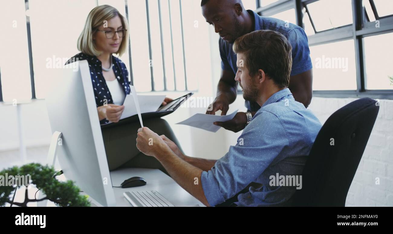 Teamwork, documents and review with business people at computer for ...