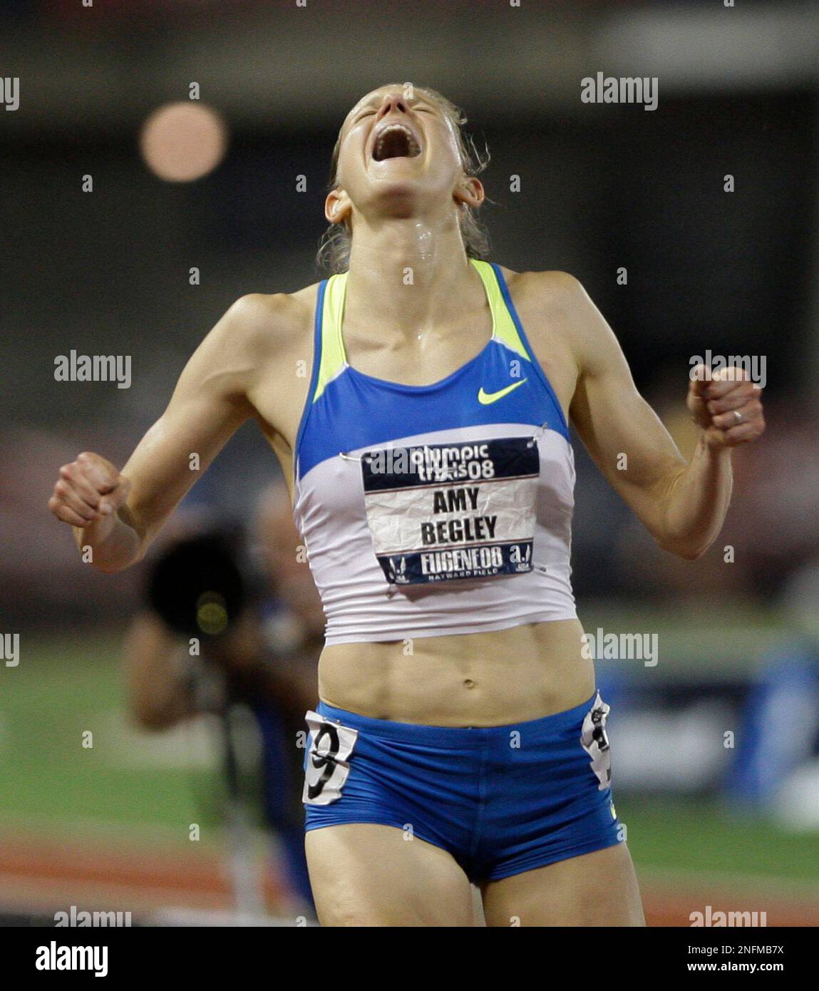 Amy Begley reacts after crossing the finish line in the women's 10,000 ...