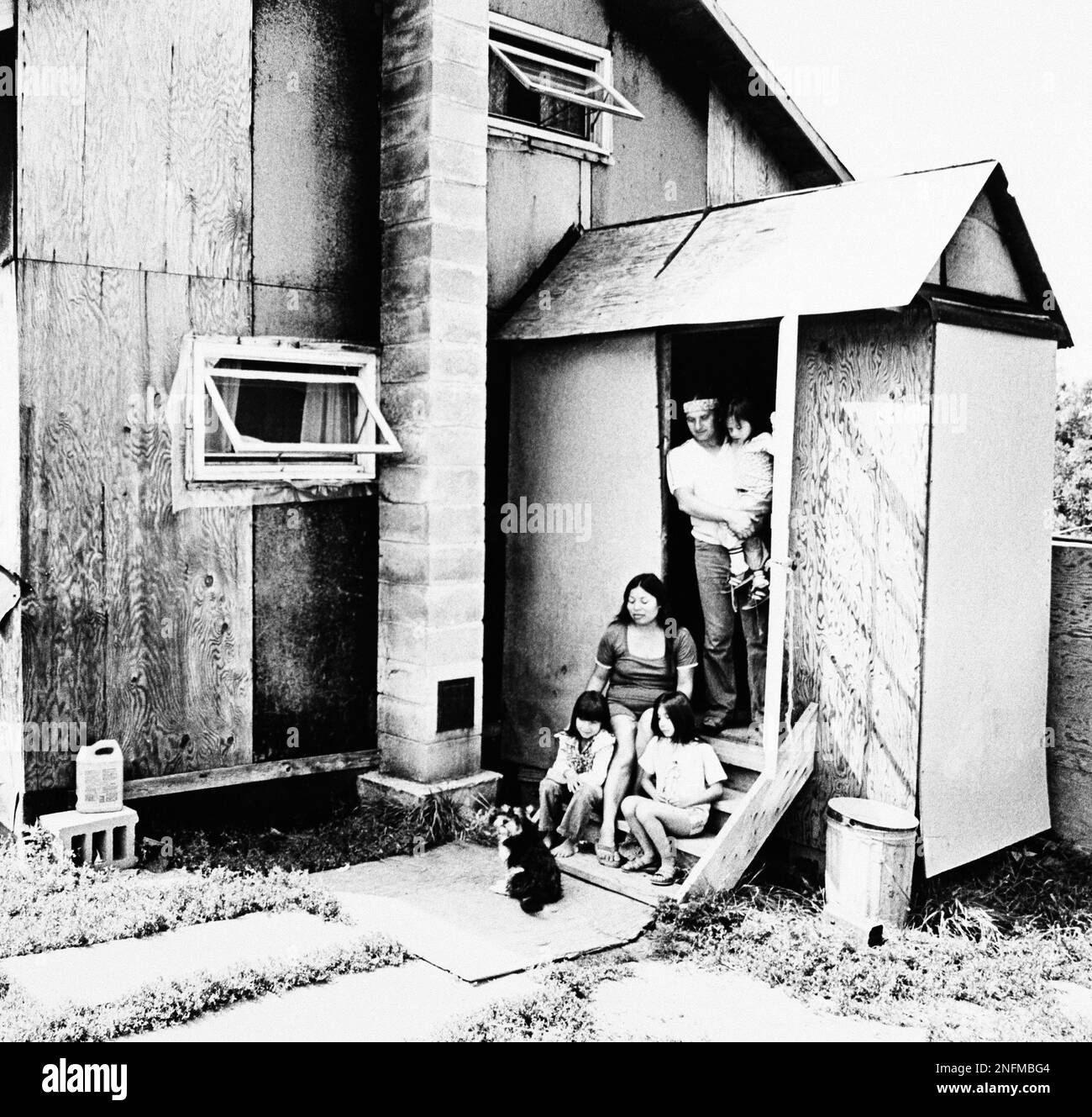 Tom Porter, a traditional Mohawk chief, holds one of his children as he ...