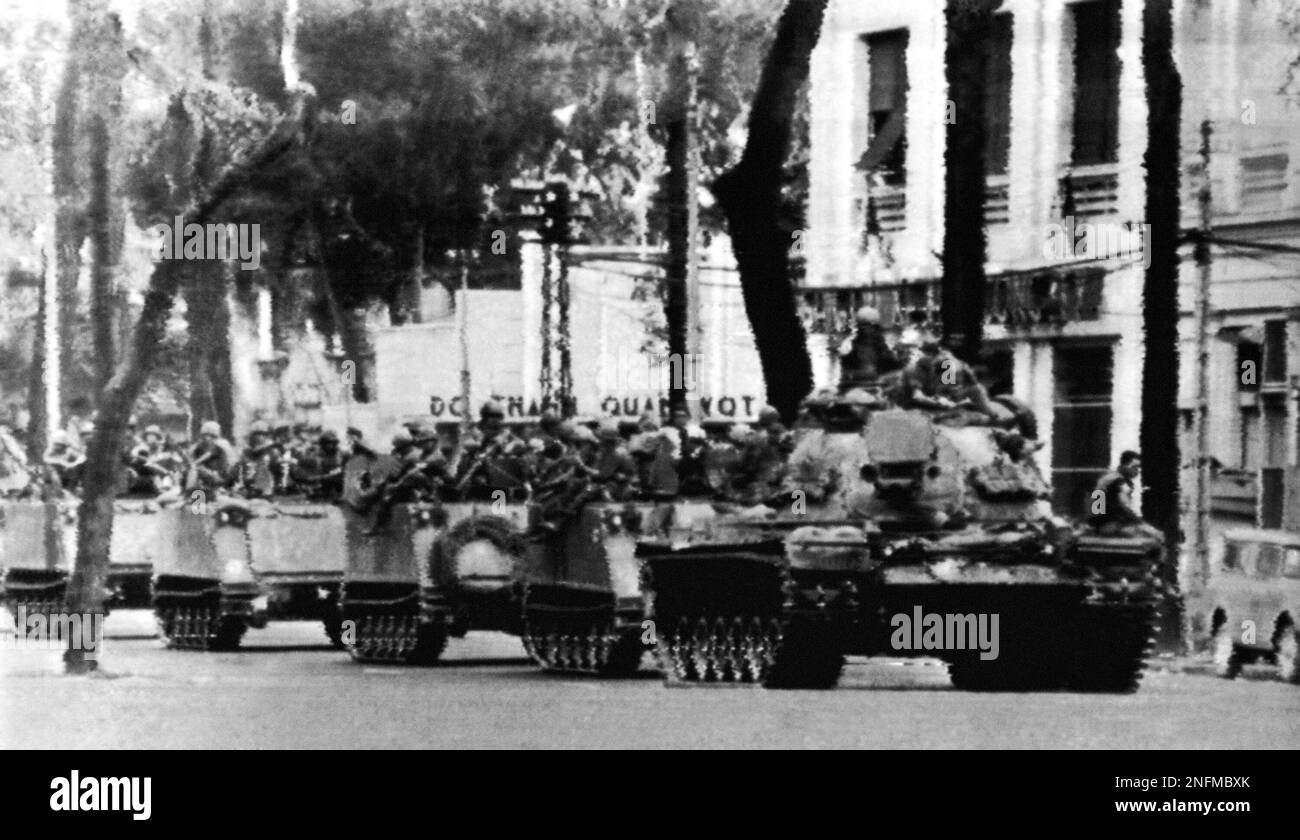 American troops in armored vehicles move through the center of Saigon ...