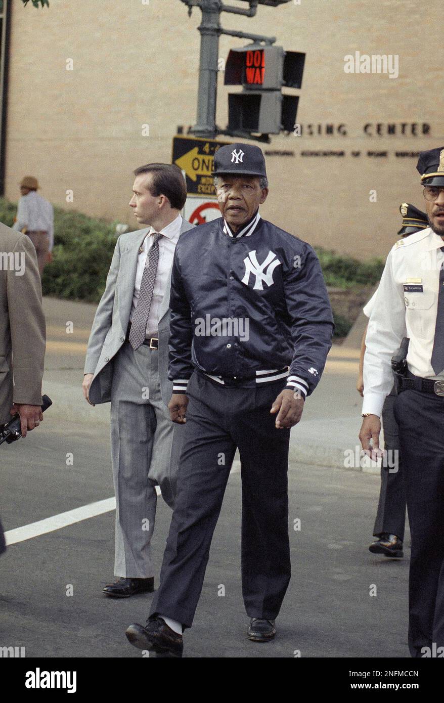 Nelson Mandela, wearing a New York Yankee cap and jacket, takes an ...