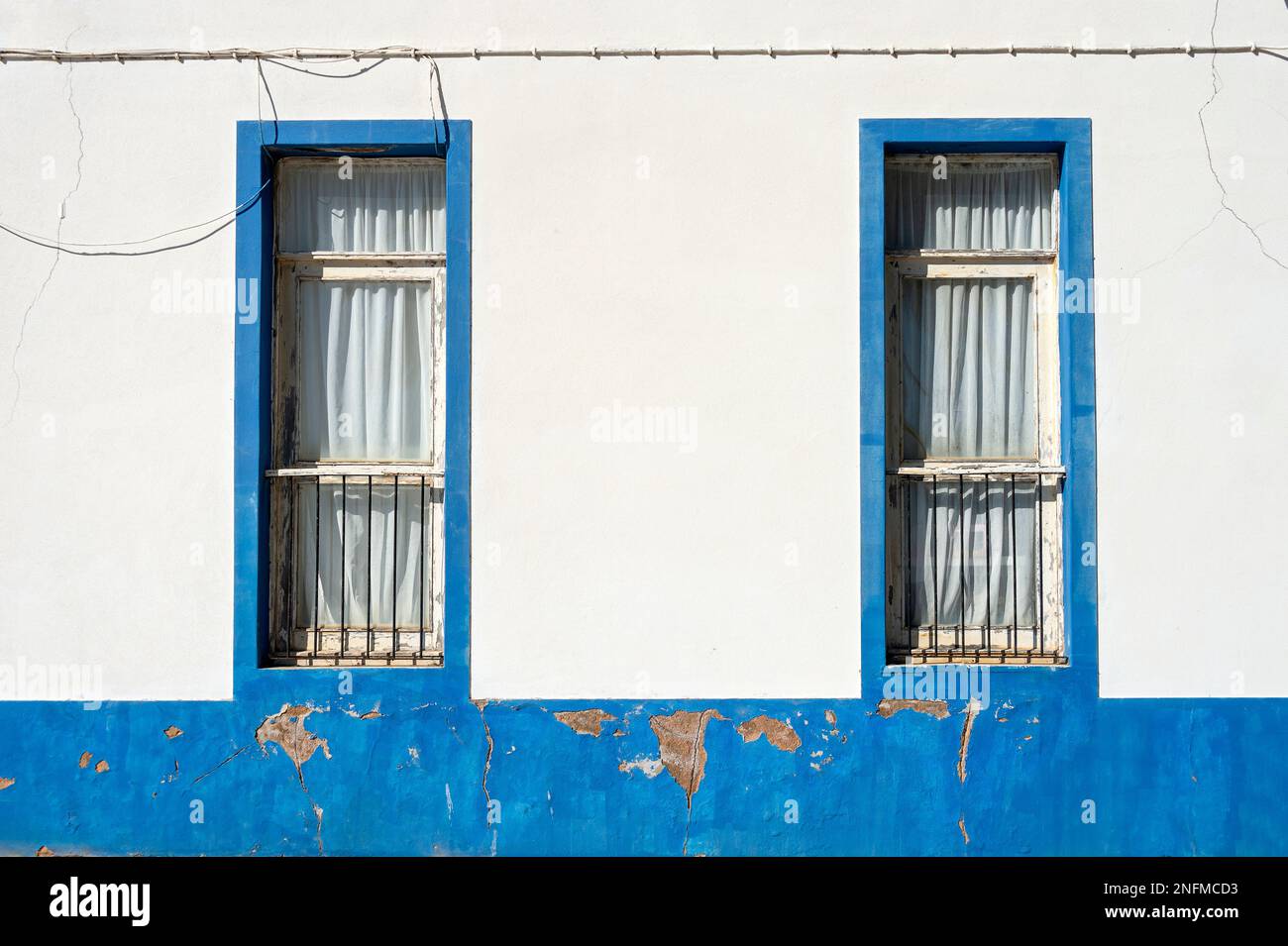 Facade of white building with blue and white painted render Stock Photo ...