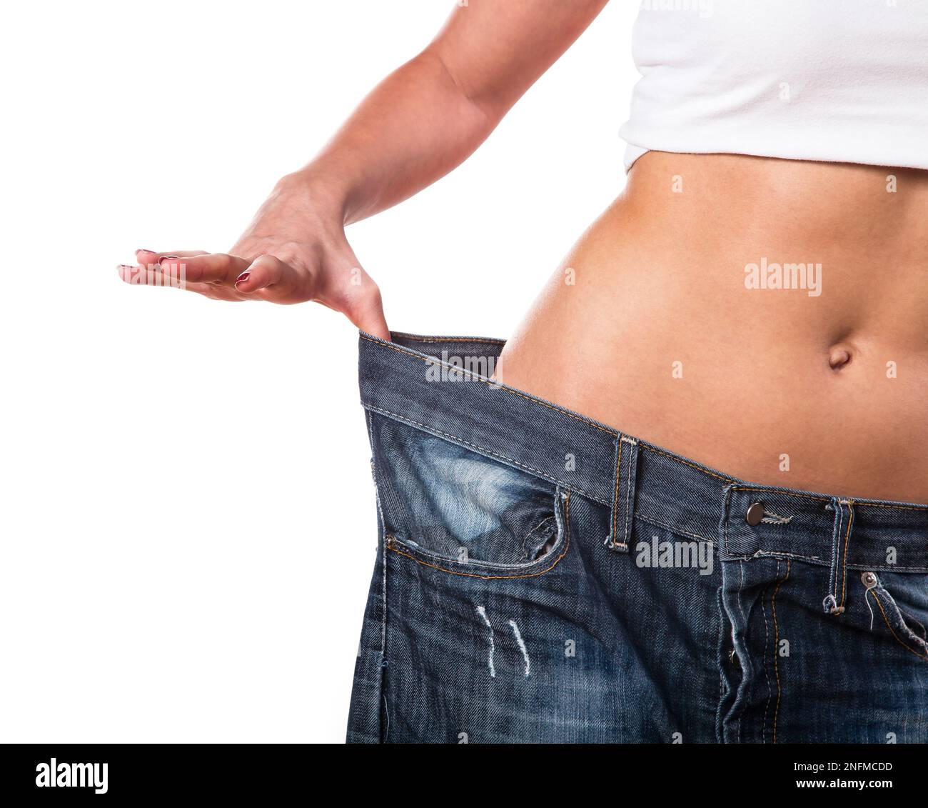 A fit girl stretching her jeans, demonstrating a large gap around her ...