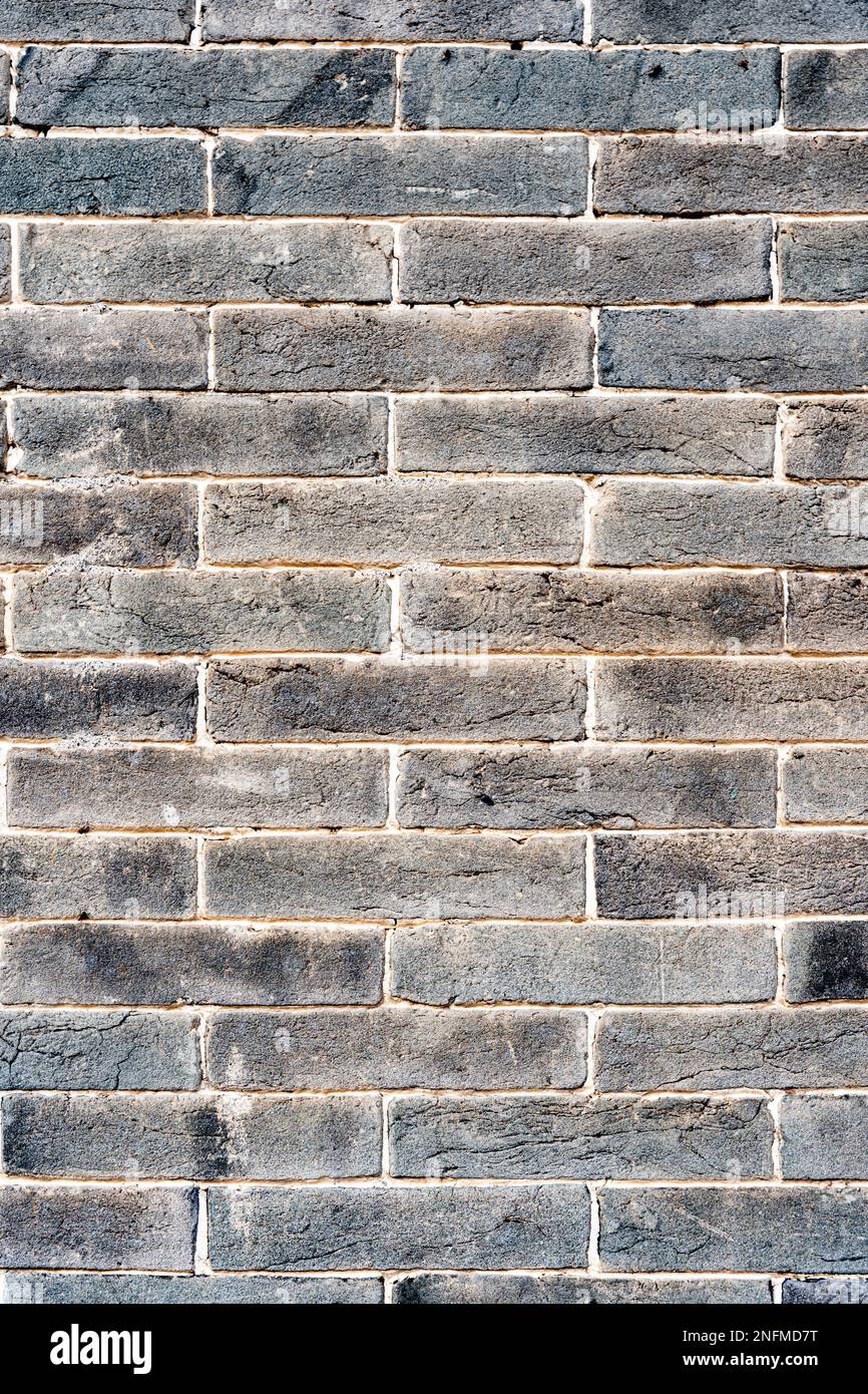 A plain brick wall background with multi-colored bricks ranging from ...