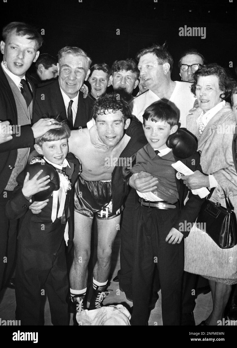 Britain's Howard Winstone hugs his two sons, Roy, 10, left, and Wayne ...