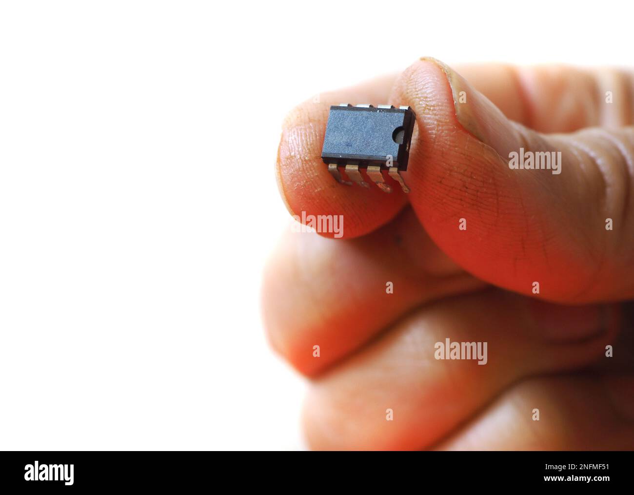 Editable blank chip surface. Fingers holding electronic chip on ...