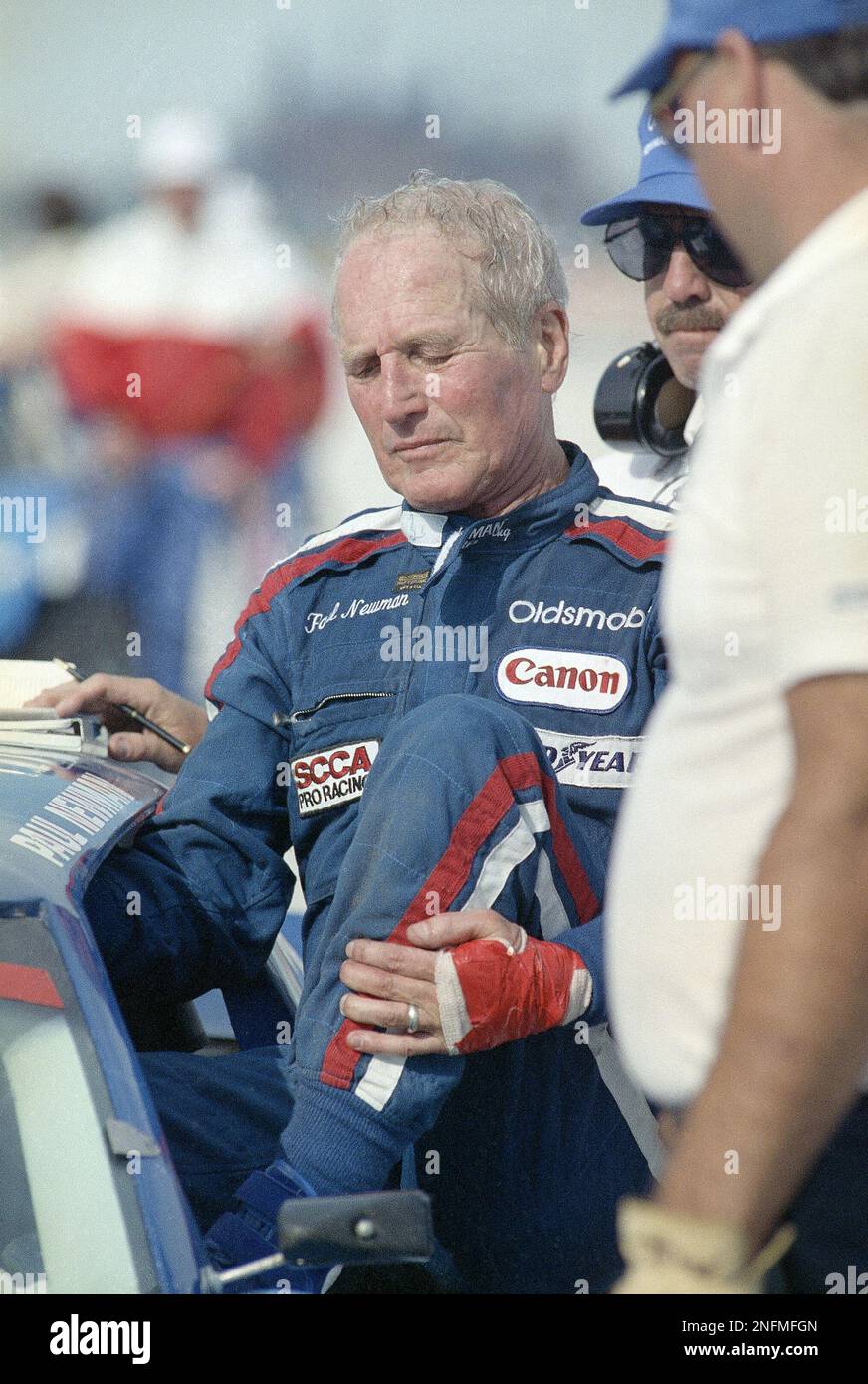 Actor Paul Newman climbs out through the window of his Trans-Am racer ...