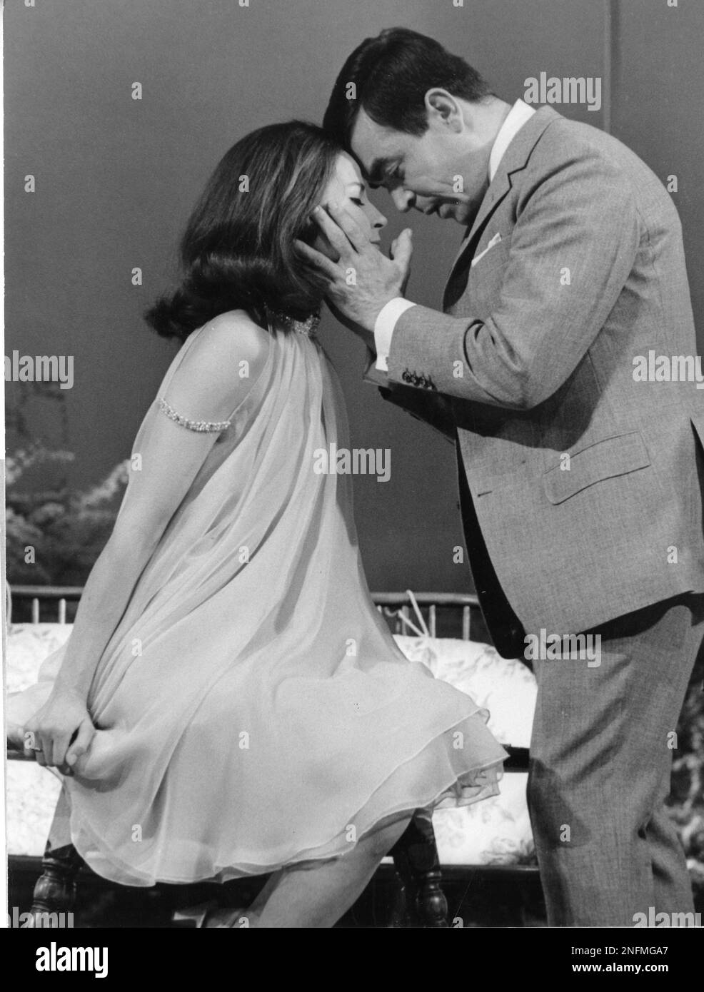 German actor Claus Biederstaedt tenderly holds the head of actress ...