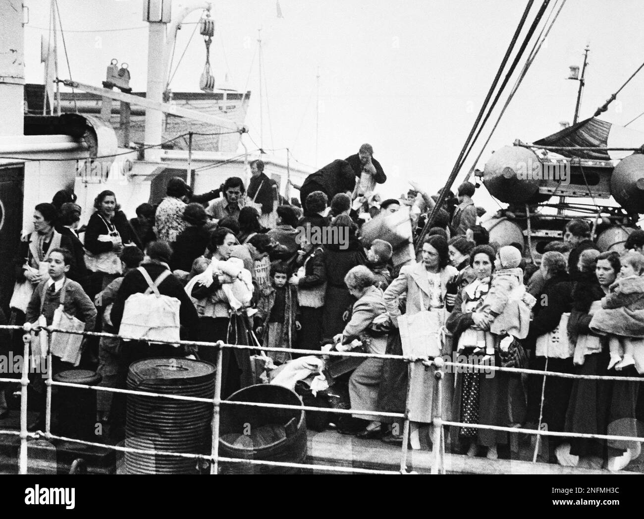 Refugees from the besieged city of Bilbao are shown aboard the ...