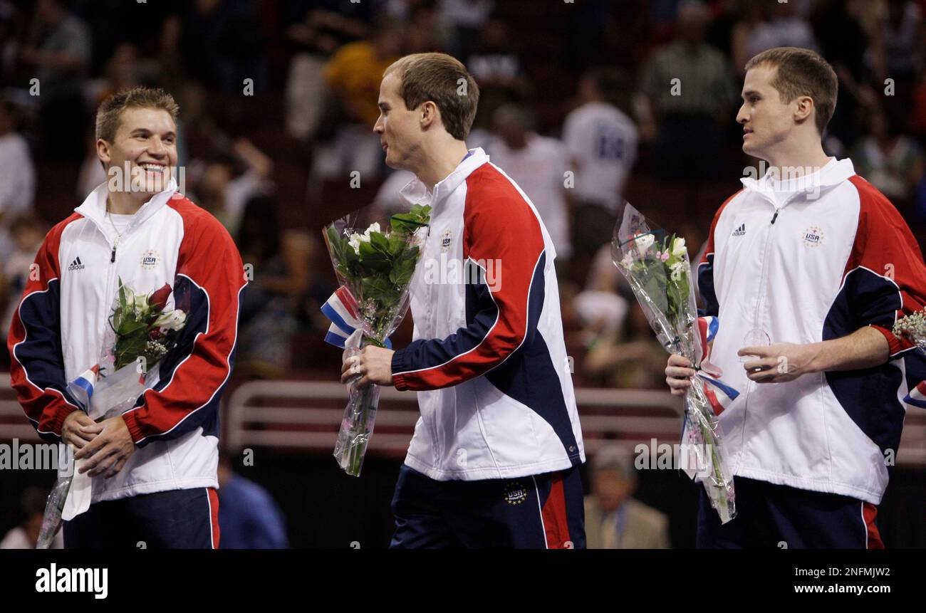 Morgan Hamm, right, looks at his brother Paul Hamm, center, and ...