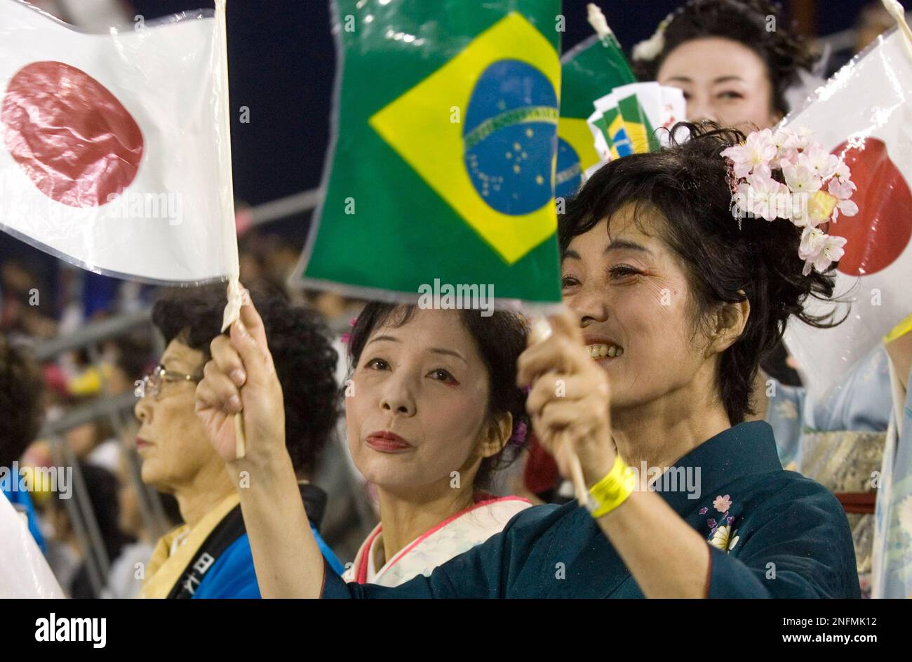 Women dressed as Japanese traditional 'Geishas' wave Brazilian and ...