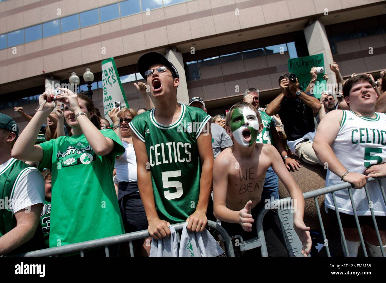Boston Celtics fans cheer the team as they pass by during a parade ...