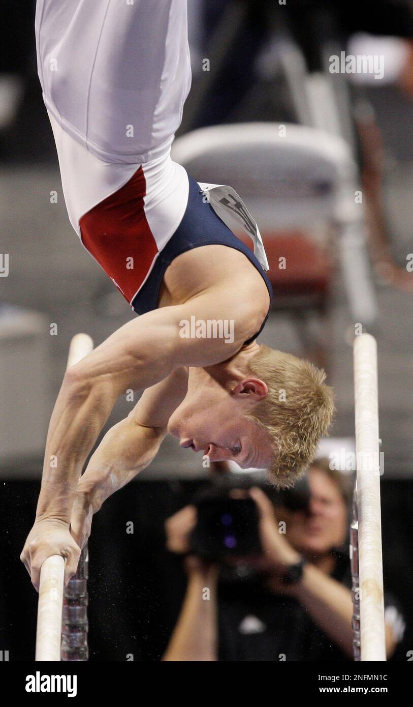 Justin Spring performs on the parallel bars during the men's first day ...