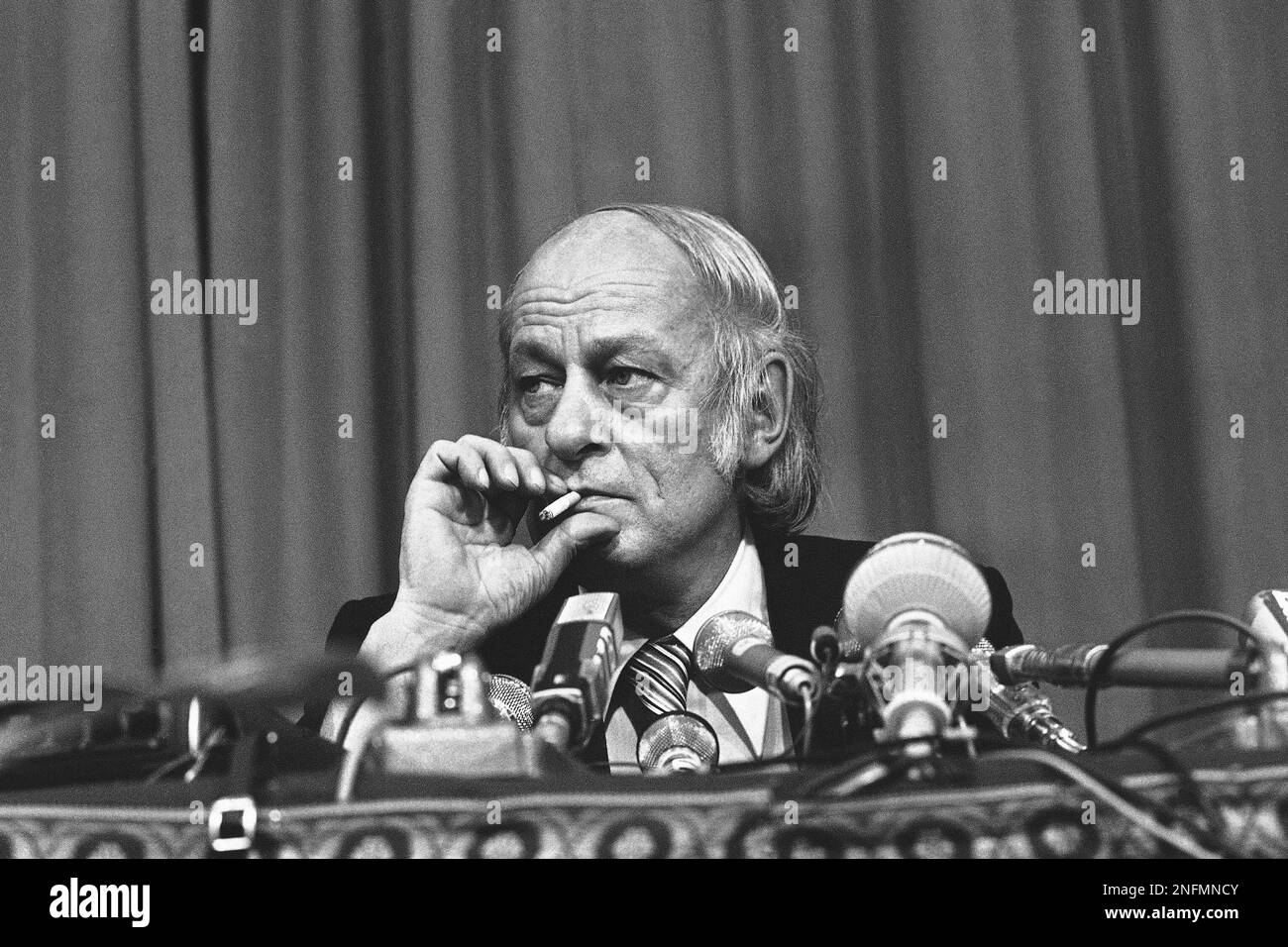 Premier Rene Levesque of Quebec puffs a cigarette while pondering on a ...