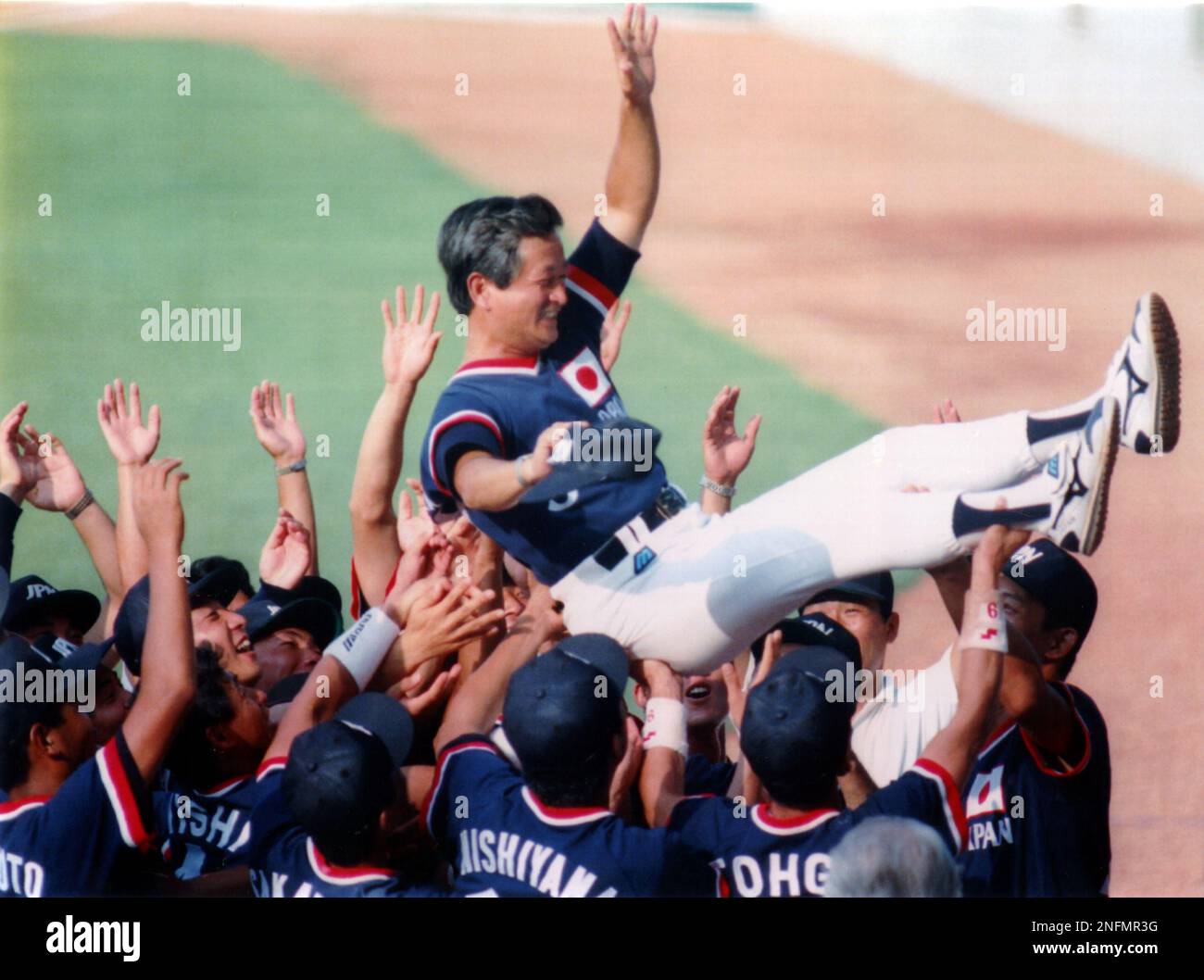 Japan baseball players lift their manager Masatake Yamanaka into the ...
