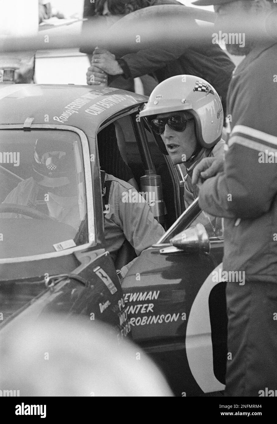 Actor Paul Newman talks to co-driver Milt Minter (behind wheel) as ...