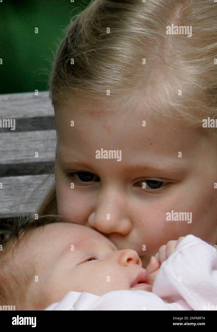 Belgium's Princess Elisabeth kisses her sister Princess Eleonore during ...