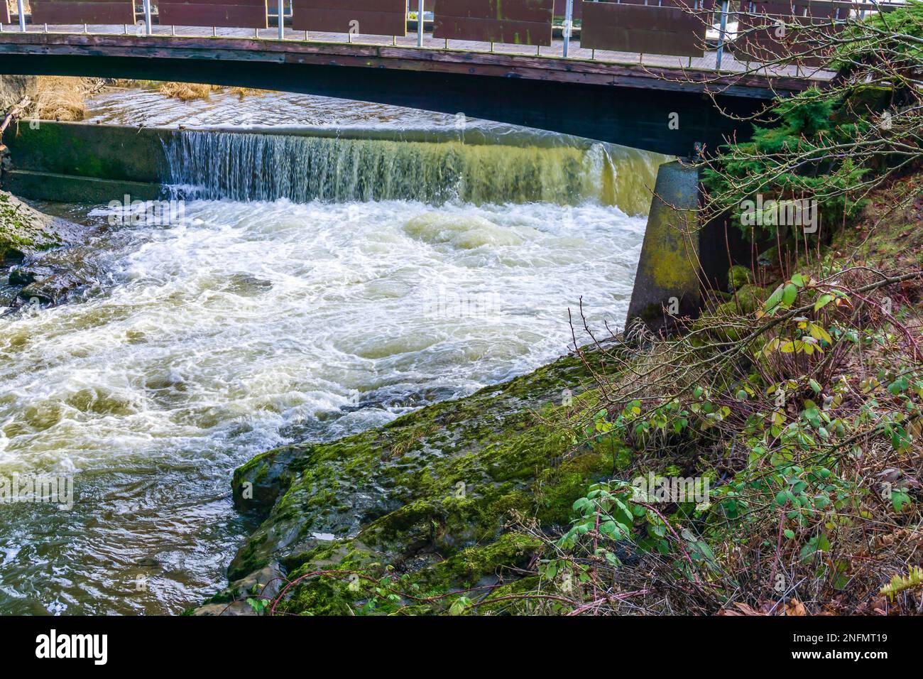 A waterfall under a walking bridge in Tumwater, Washington Stock Photo ...