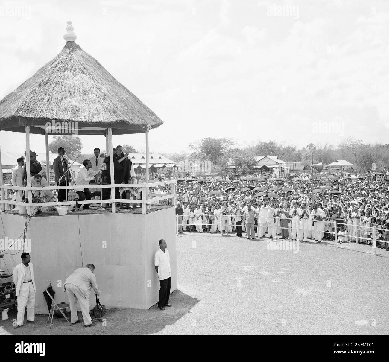 From a high Rostrum under a thatched roof, the Dalai Lama god-king of ...