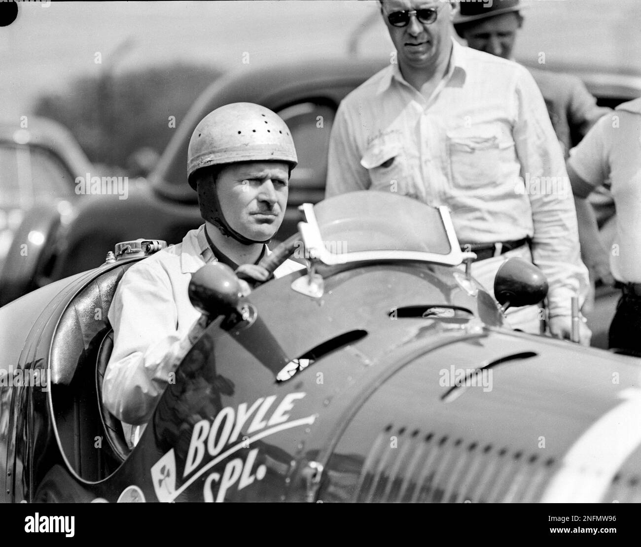 Wilbur Shaw, Indy 500 winner in 1937 and 1939, sits at the wheel of his ...